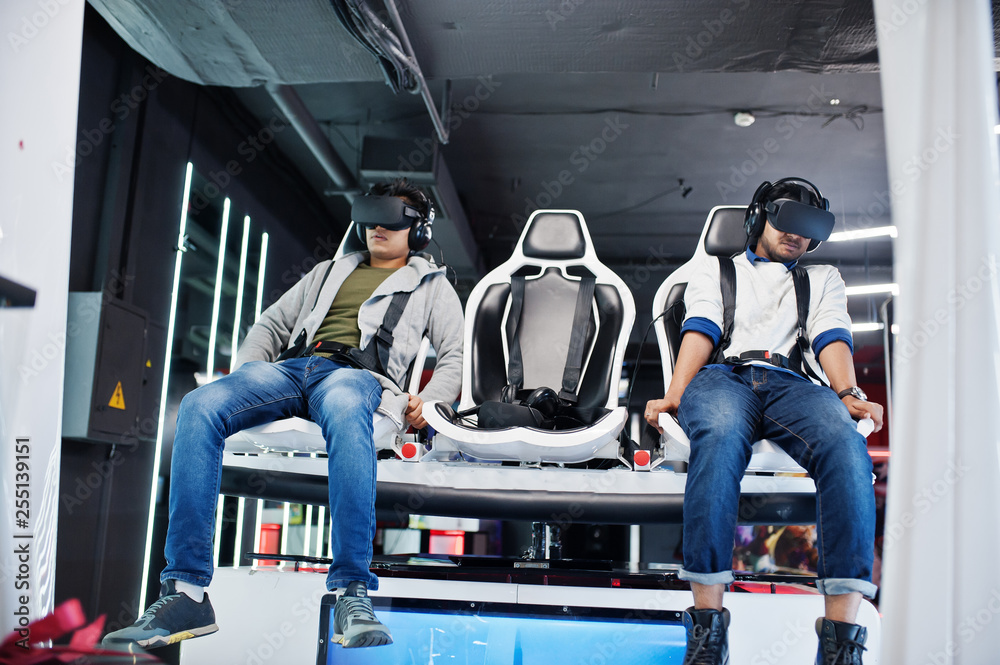 Two young indian people having fun with a new technology of a vr ...
