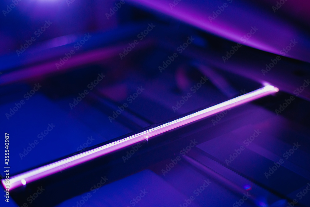 Copier scanner with a bright light inside. Office hazards concept ...