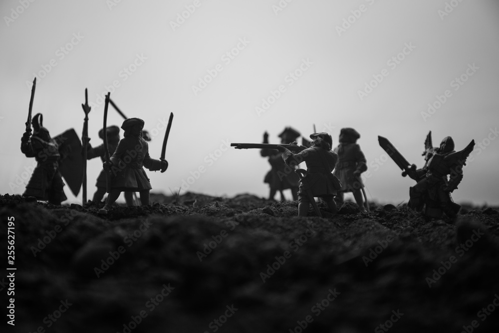The musketeer in a black broad-brimmed hat fires an old brown musket ...