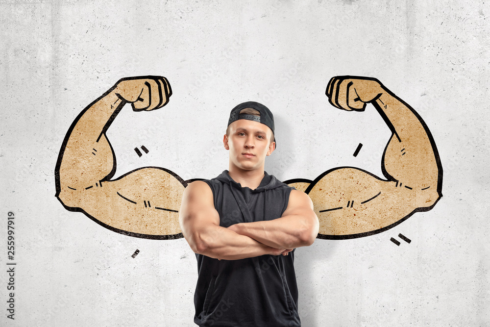 Close up front view of young athletic man with arms crossed, standing ...