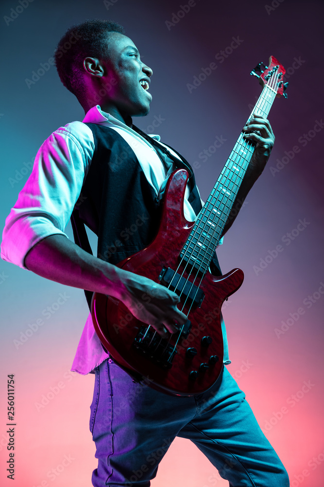 African American handsome jazz musician playing bass guitar in the ...