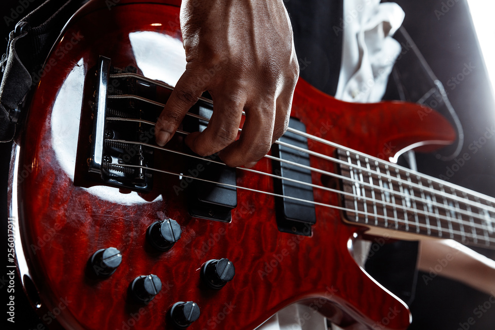 African American handsome jazz musician playing bass guitar in the ...
