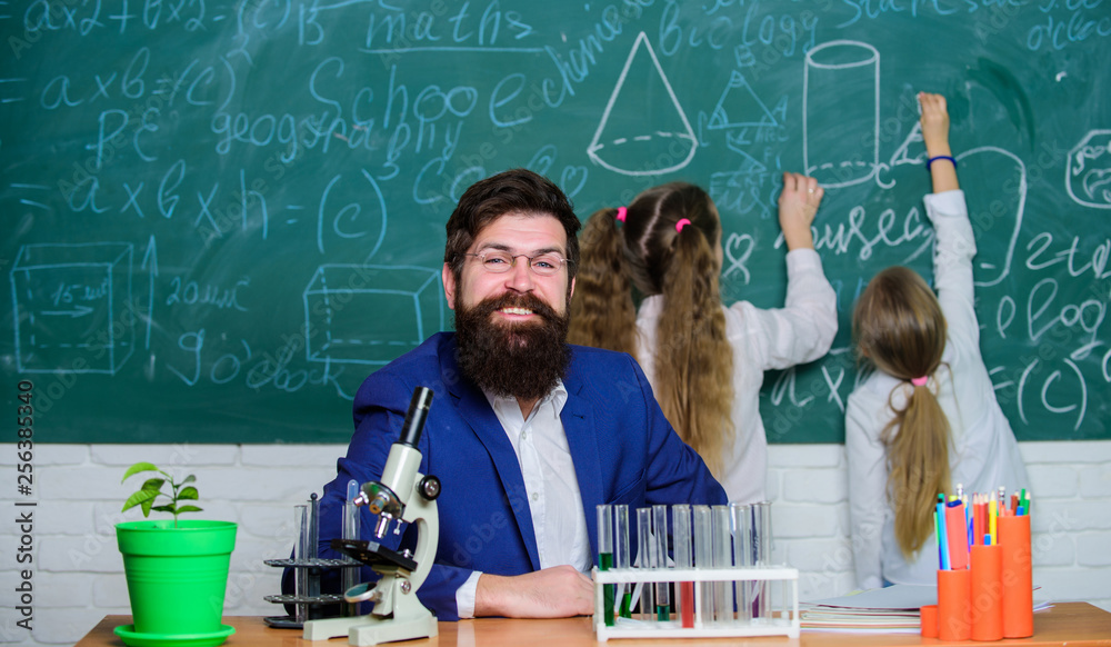 Man bearded teacher work with microscope and test tubes in biology ...