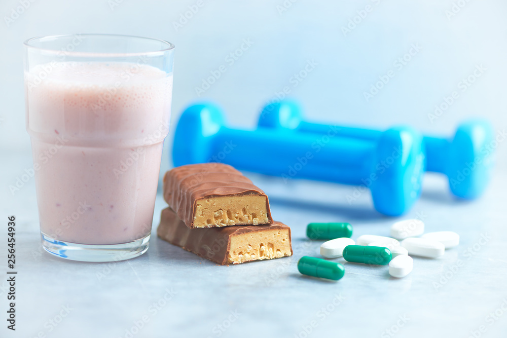Protein bar, glass of protein shake with milk and raspberries. BCAA ...