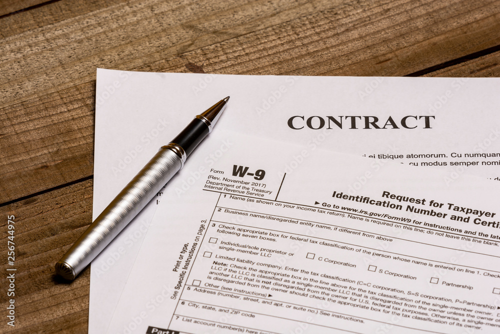IRS form W-9 and a contract Stock Photo | Adobe Stock