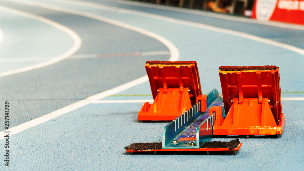 Athletics starting blocks on race blue track Stock Photo | Adobe Stock