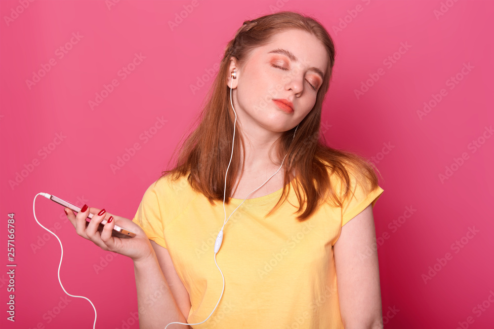 Dreamy female with pensive expression and closeed eyes, has modern ...