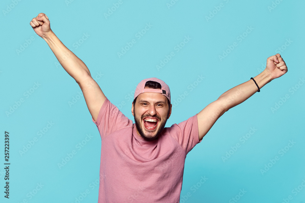 Successful caucasian male holding hands up, achieves cherished goal ...
