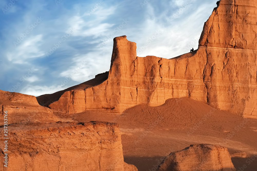 Sandy red rocks against the blue sky with white clouds in the desert of ...