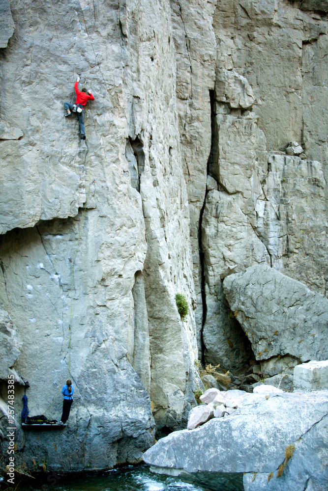 Mitch Underhill reaches for a hold and Sarah Felchlin belays while ...