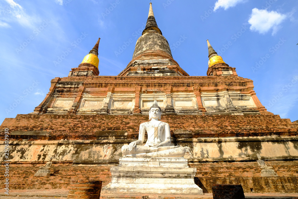Front face view of white Lord Buddha statue and three big ancient ...