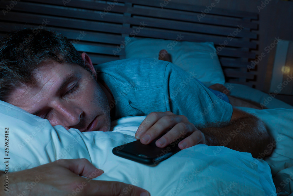 lifestyle portrait of young tired and exhausted man sleeping or falling ...