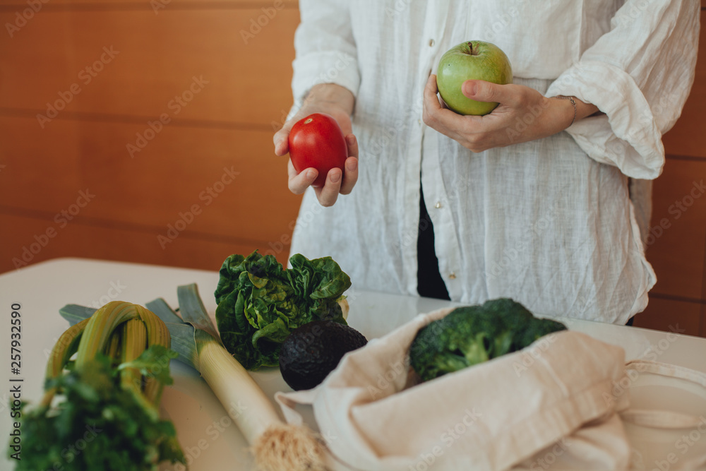 Crop picture of young girl with eco friendly natural bag with fruit and ...