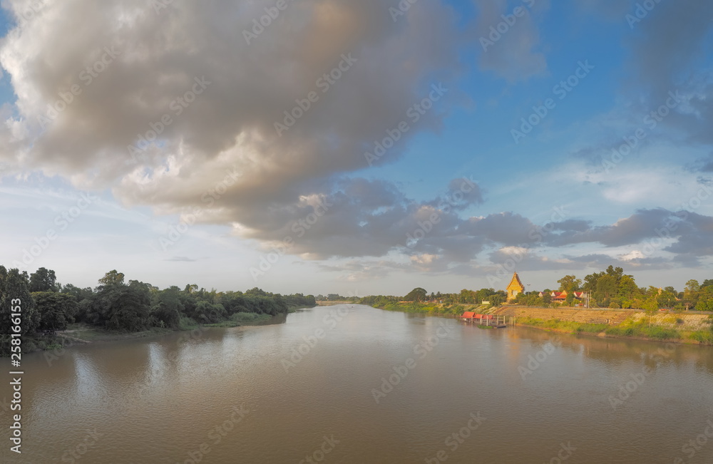 river view of dark clouds moving above Maeklong river with blue sky ...