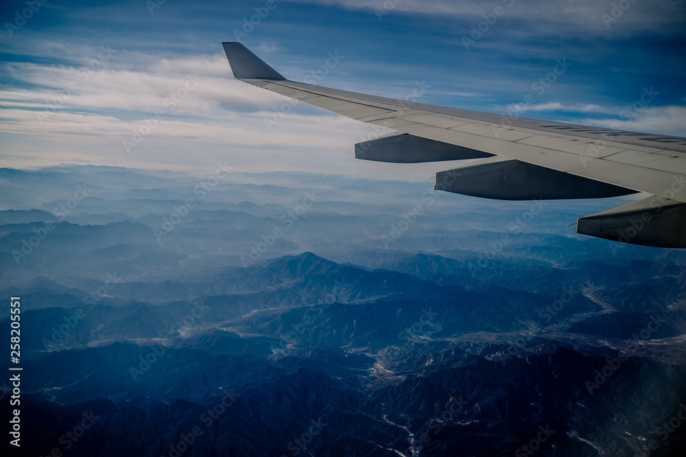 An aerial view of Chinese mountains from the airplane flying high above ...