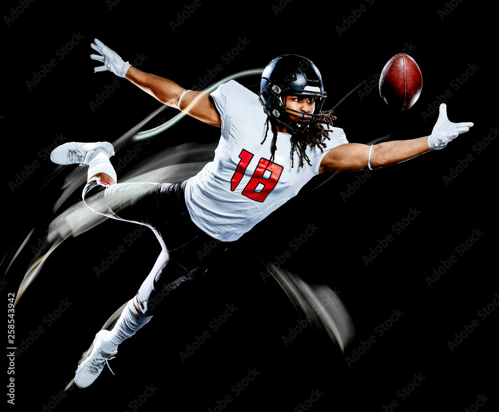 one african american football player man studio shot isolated on black ...