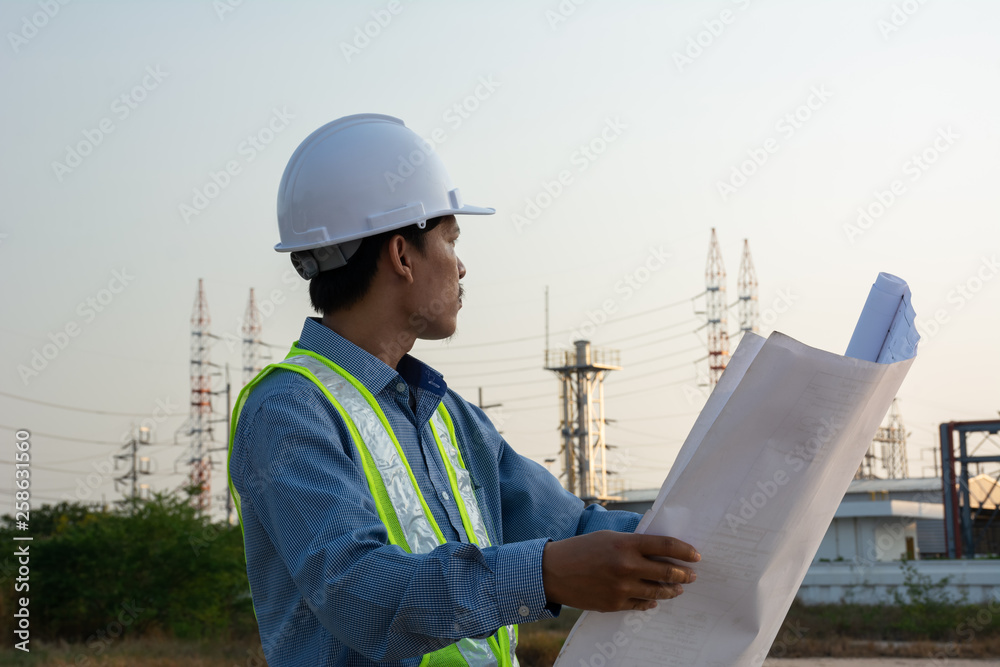 Engineers male are looking at blueprint for workers security control at ...