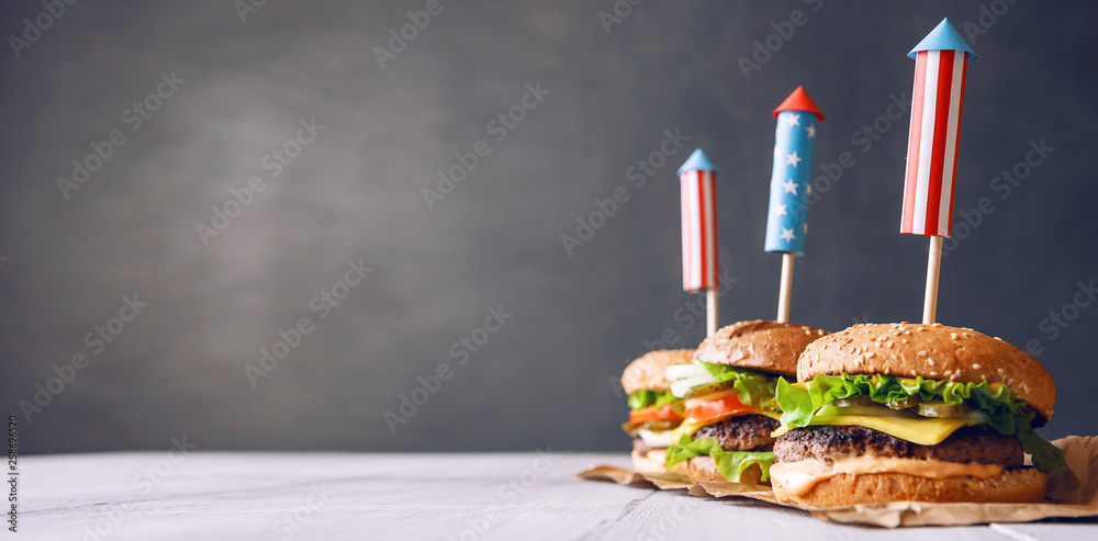 Stock-Foto „three fresh and juicy burgers with American flag-style ...