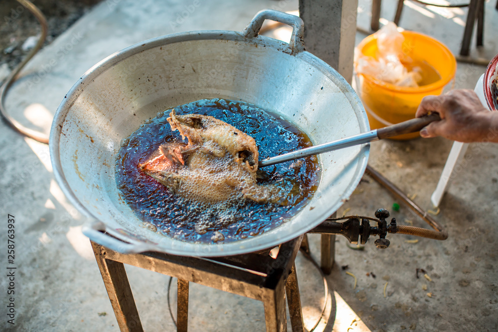 chef cooking deep-fried fish in the big pan to Chinese banquet food ...
