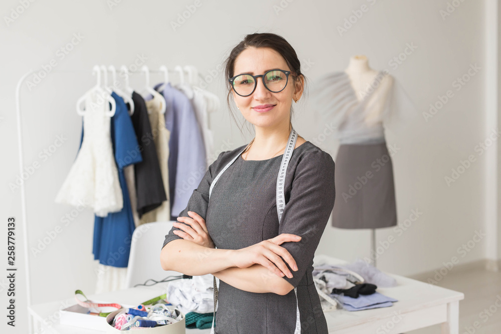 Dressmaker, fashion designer and tailor concept - Young dressmaker ...