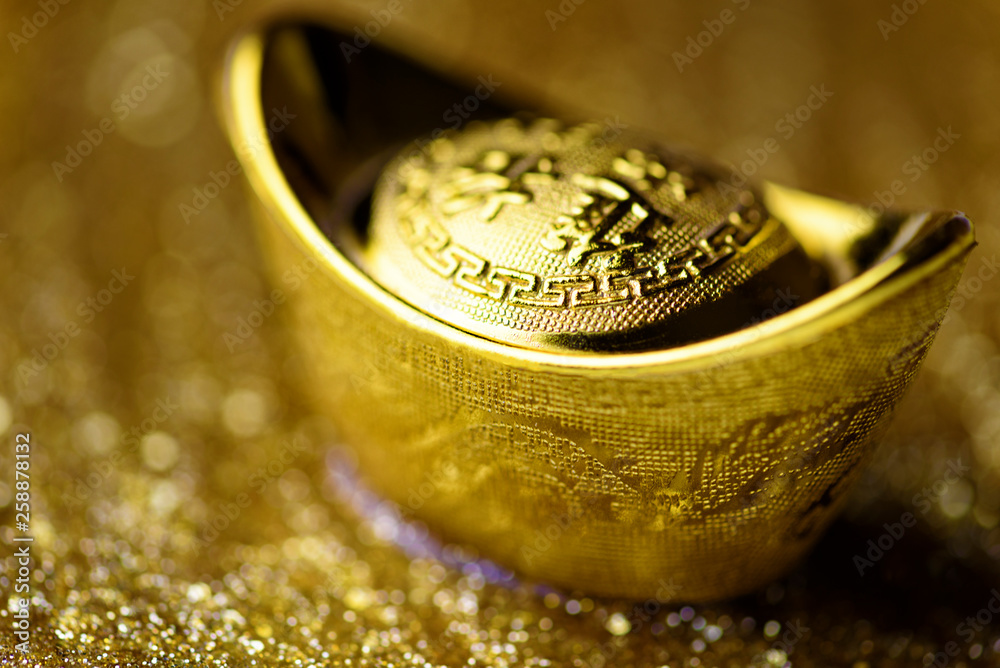 Chinese gold ingot on gold background Stock Photo | Adobe Stock