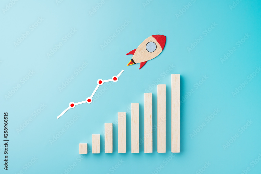 Foto Rocket and chart on blue background business financial start up ...