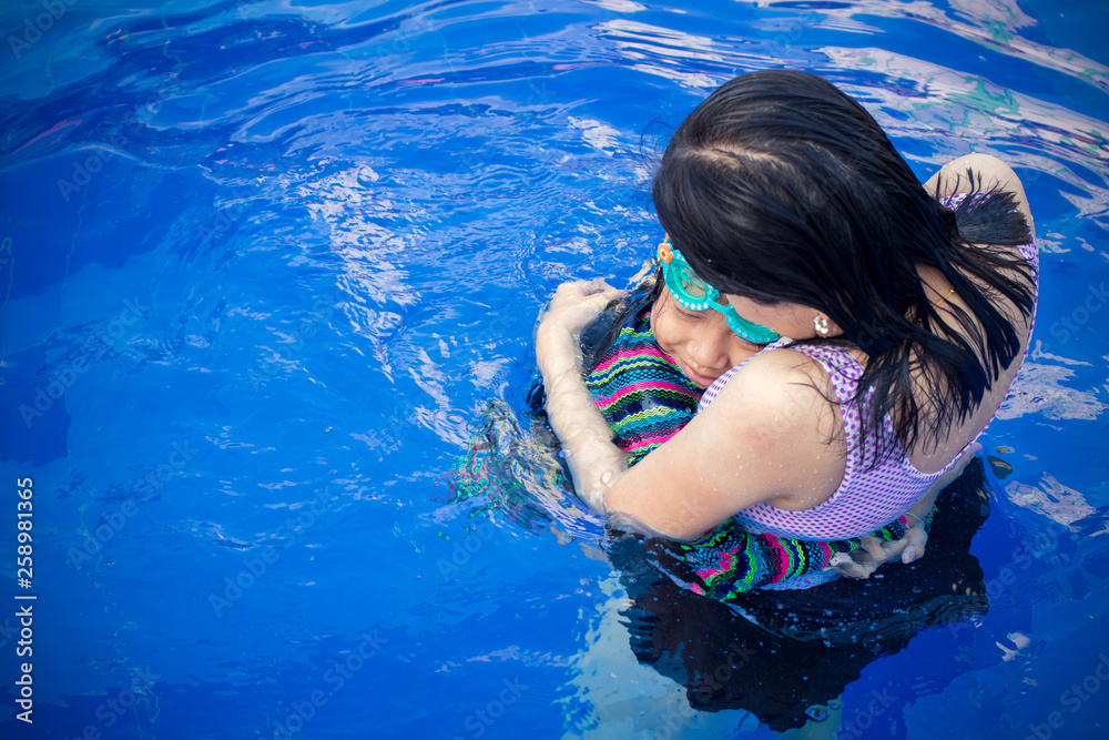 Asian daughter hugging with her mother at the swimming pool Stock Photo ...
