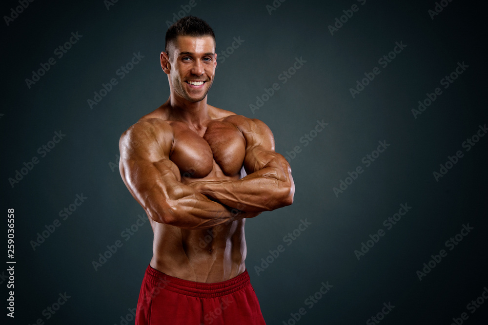 Handsome Body Builder Flexing Muscles Stock Photo | Adobe Stock