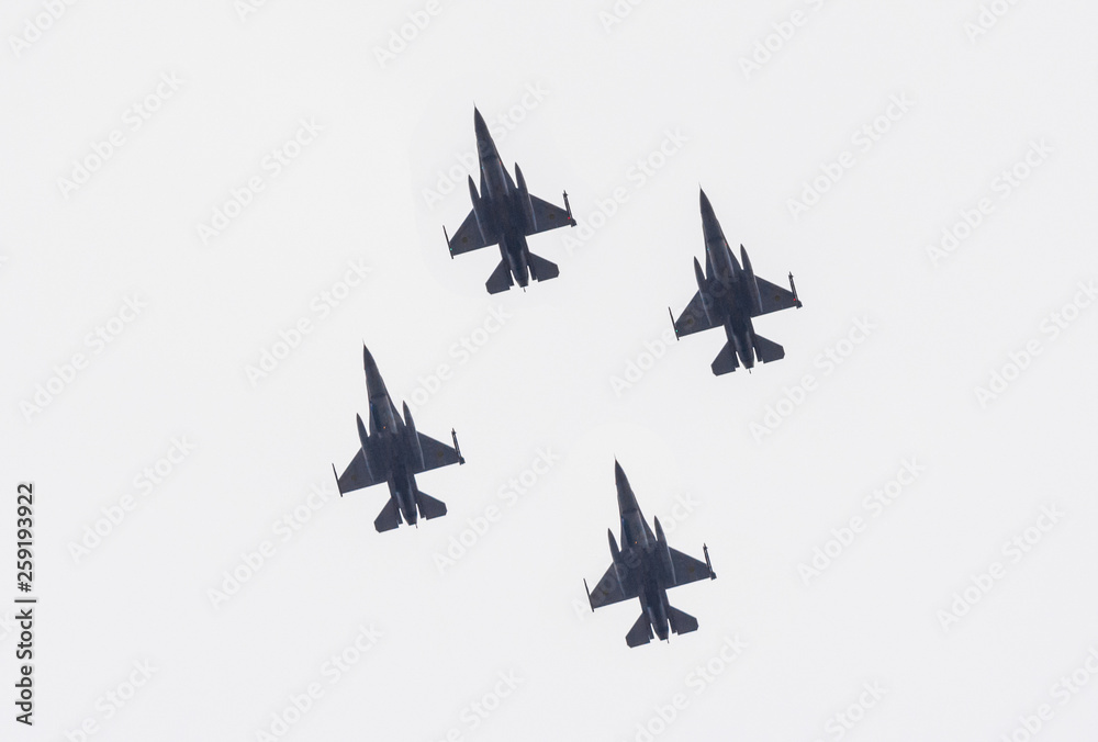 Formation of modern fighter jets in flight equipped with bombs and ...