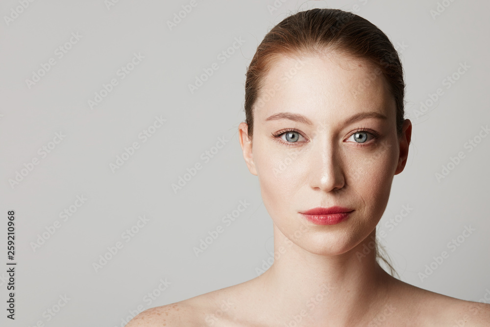 Beauty Portrait Of A Pretty Young Topless Redhead Girl With Freckles Isolated Over White