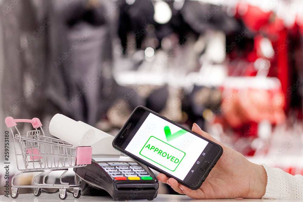 POS terminal, Payment Machine with mobile phone on store background ...
