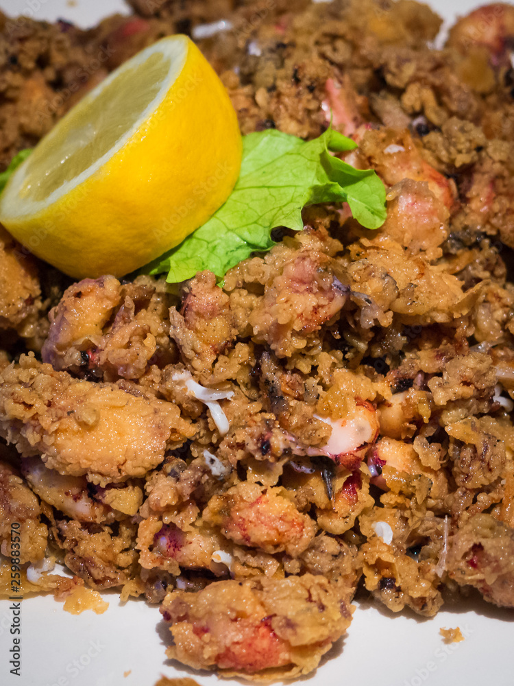 Plate of fried chopitos, small fried calamari, typical dish of Spanish ...