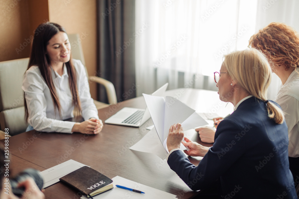 Woman job applicant having an interview with two female corporate ...