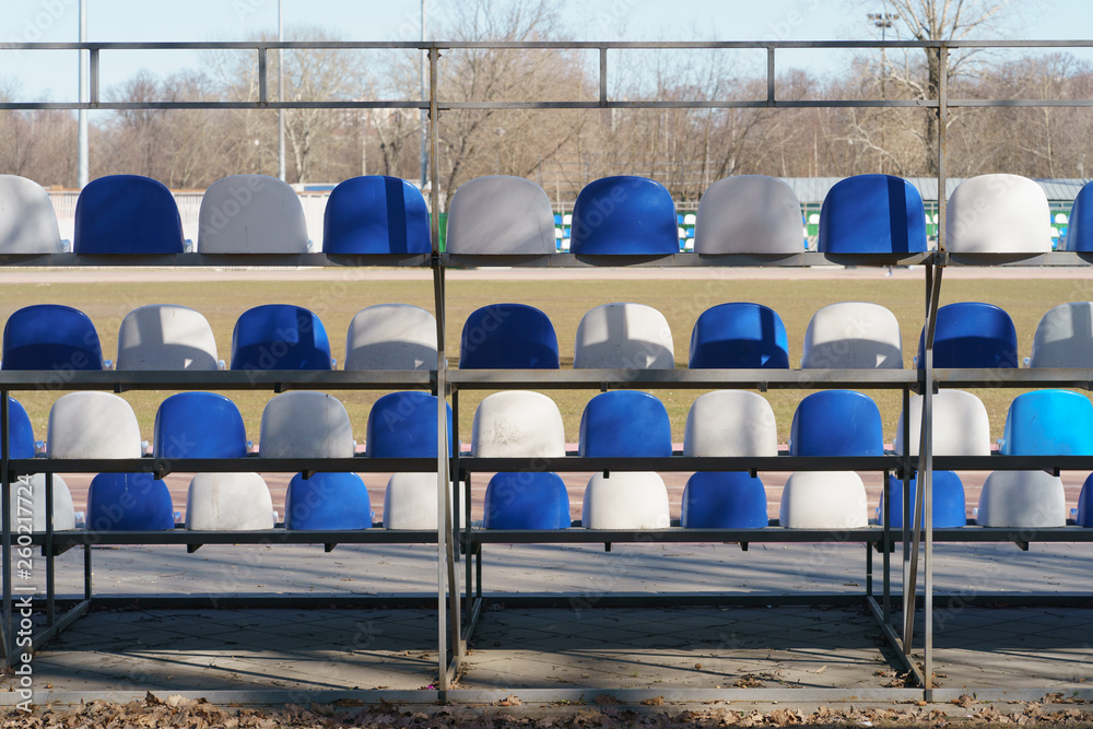 Back view of the grandstand. Amphitheater of white and blue seats ...