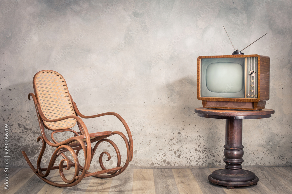 Retro old outdated TV receiver from circa 50s on wooden table and aged ...