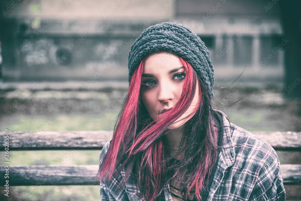 Homeless girl, Young beautiful red hair girl sitting alone outdoors ...
