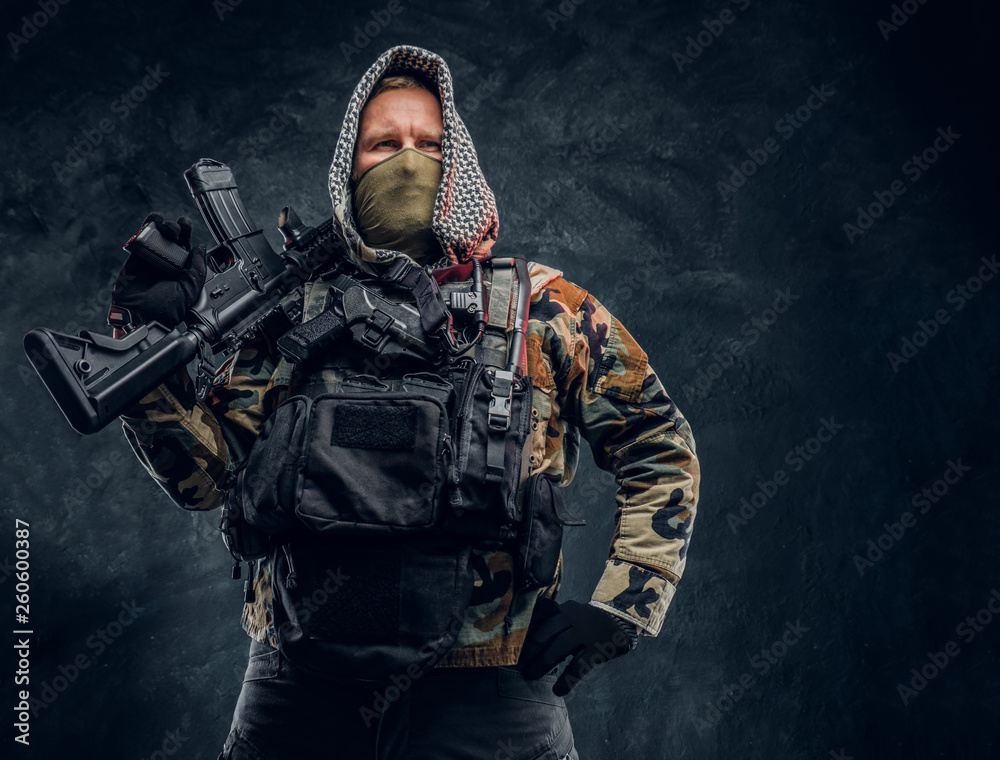 Special forces soldier in military uniform wearing mask and hood posing ...