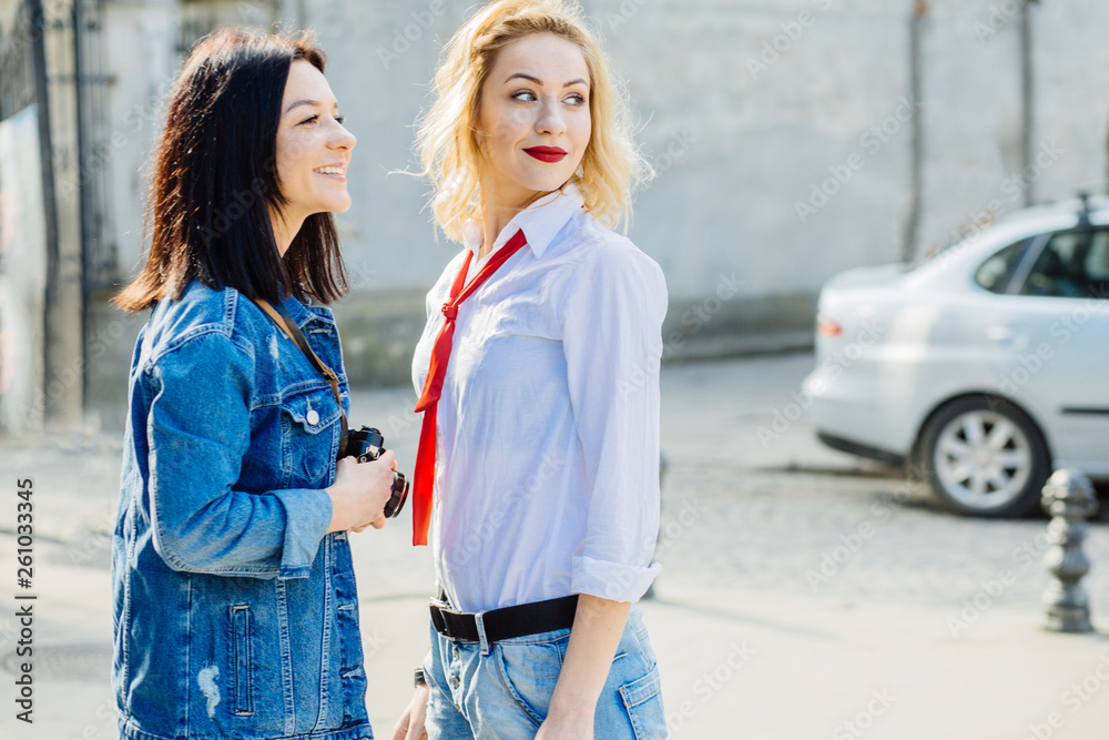 Outdoor lifestyle portrait of two best trendy female friends, having ...