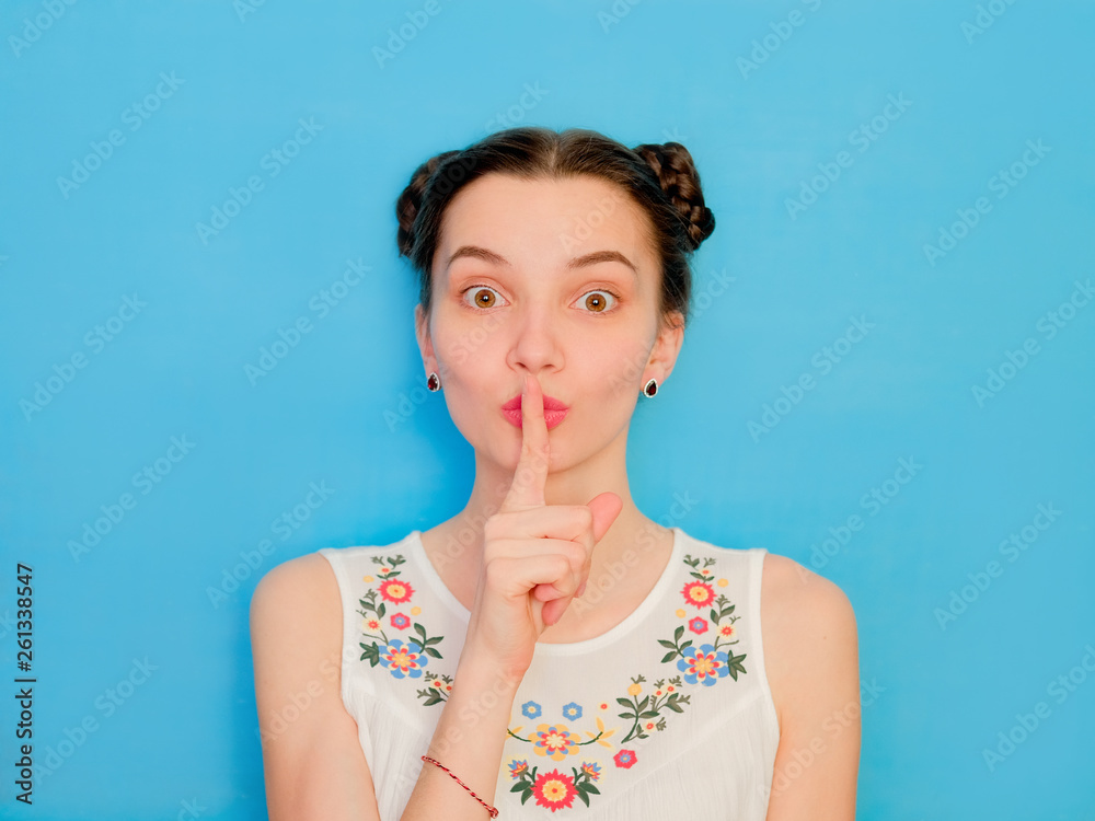 Funny cute girl on a blue studio background. Bright emotional female ...