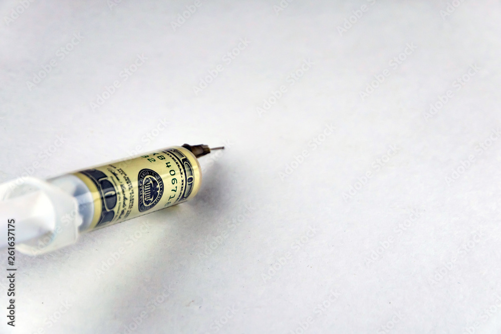 financial injections, money entry: a banknote of $ 100 inside a syringe ...