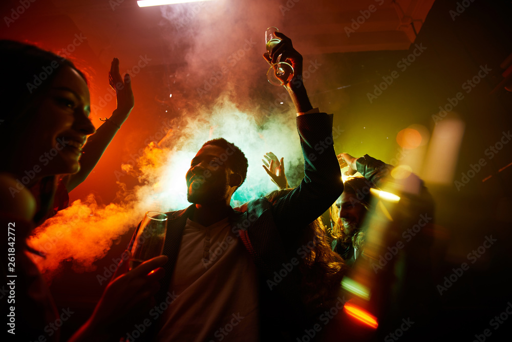 Crowd of cheerful hilarious young multiethnic people drinking alcohol ...