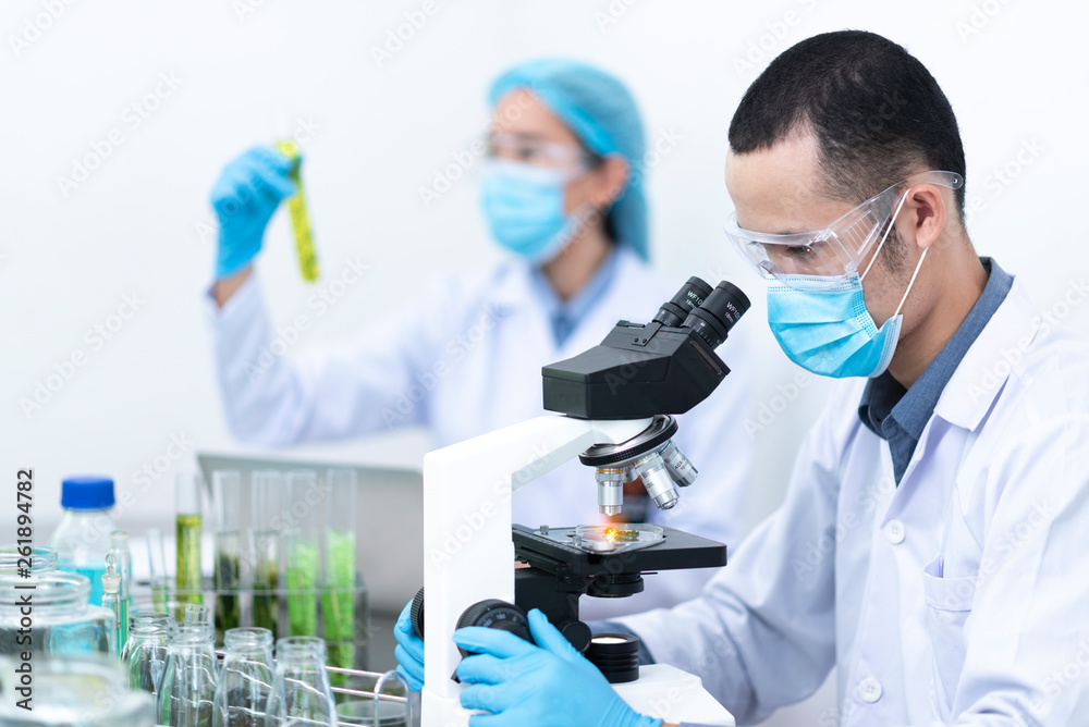 Health care researchers working in life science laboratory. Young ...