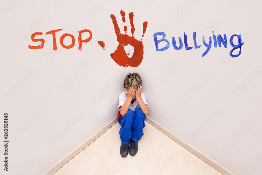 crying child in school uniform and written English text STOP BULLYING ...