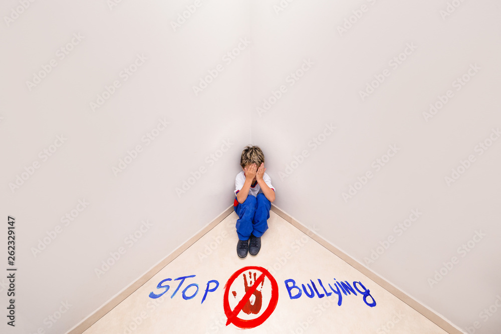 crying child in school uniform and written English text STOP BULLYING ...