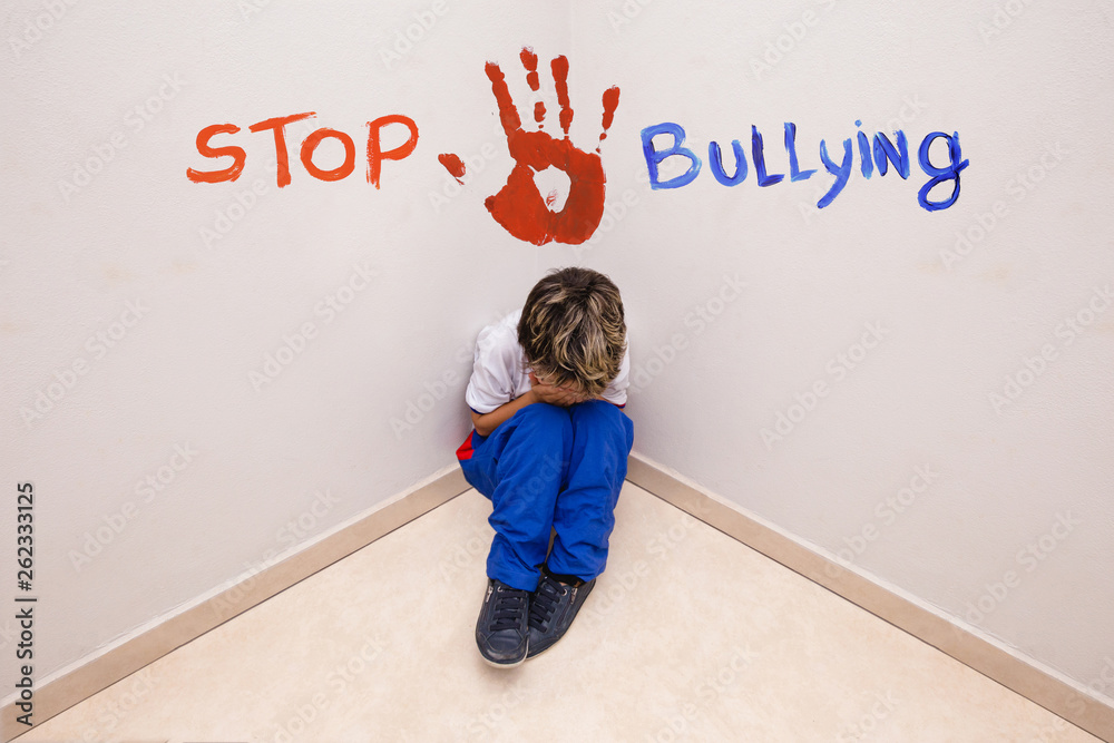 crying child in school uniform and written English text STOP BULLYING ...