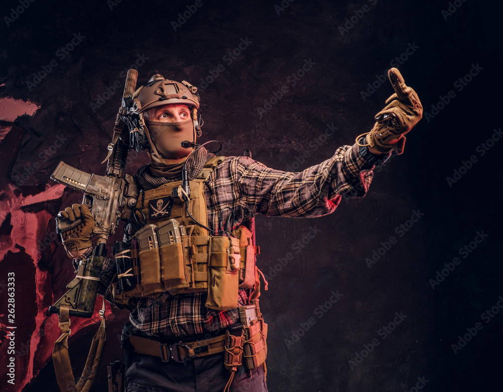 Special forces soldier in camouflage uniform posing with assault rifle ...
