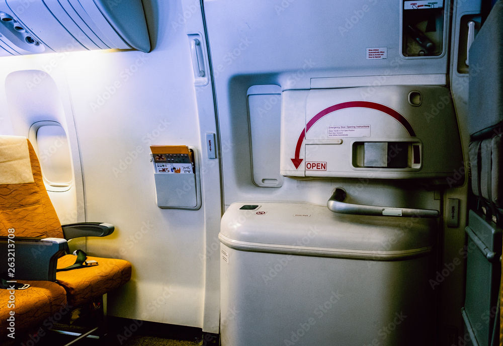 Aircraft interrior with the airplane's entrance, the flight attendant ...