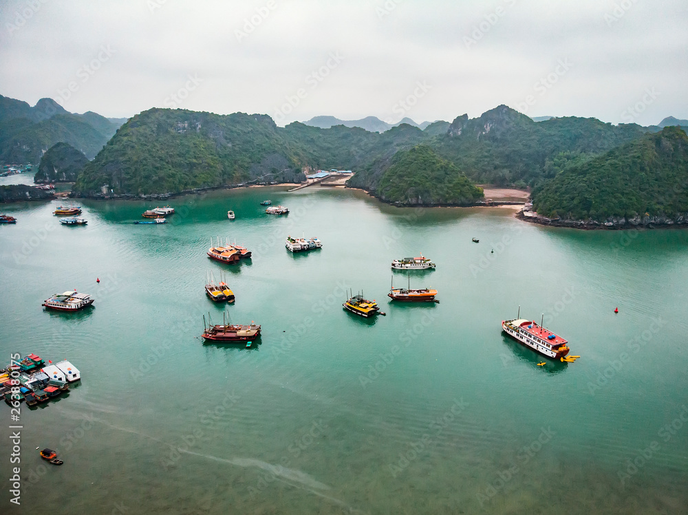 Exploring the islands and grottoes of Halong Bay is best done using one ...