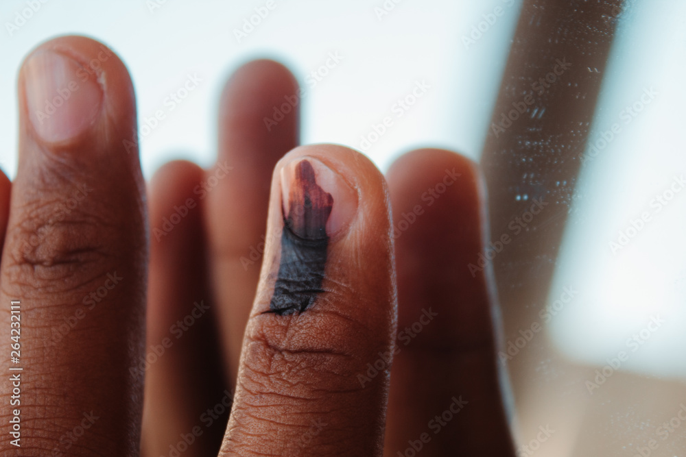 Reflection of the finger of an Indian man who voted for the elections ...