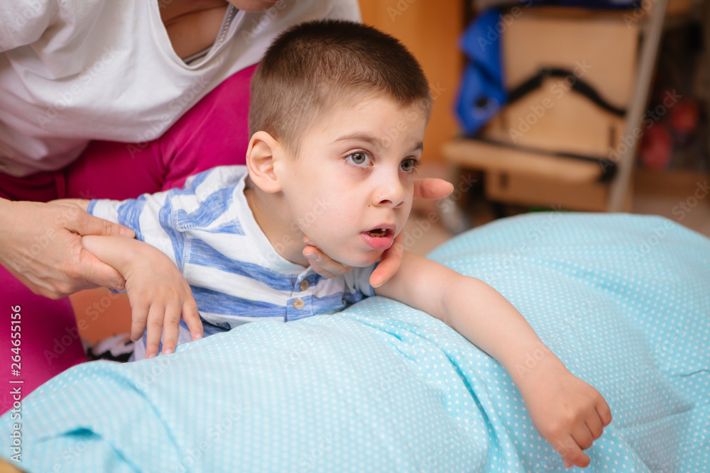 little kid with cerebral palsy has musculoskeletal therapy by doing ...